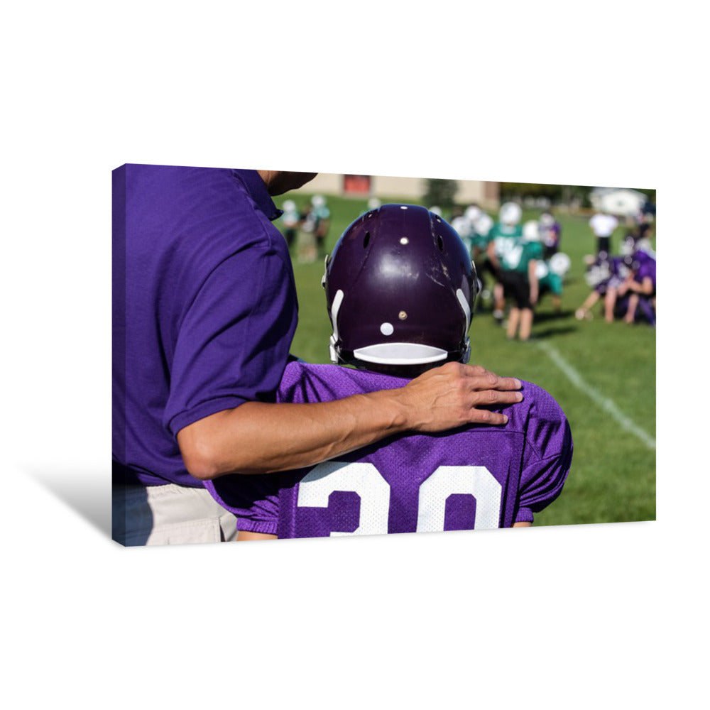 Coach With His Arm Around His Player On The Sidelines Canvas Print